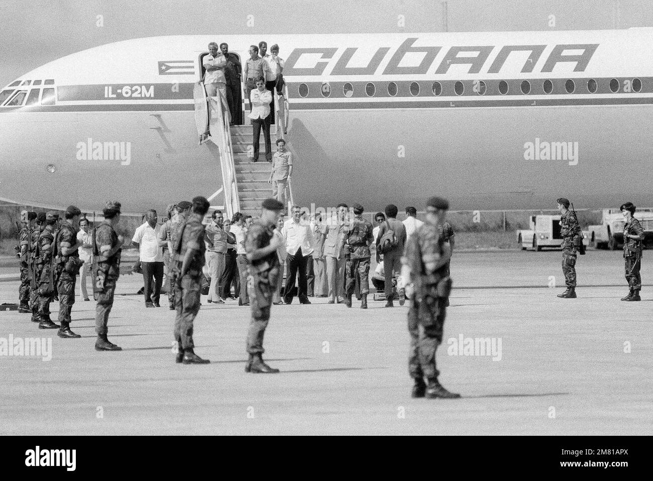 A US Air Force security police stand guard as Cuban nationals prepare ...