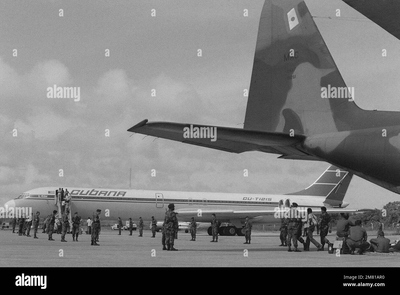 A US Air Force security police stand guard as Cuban nationals are ...