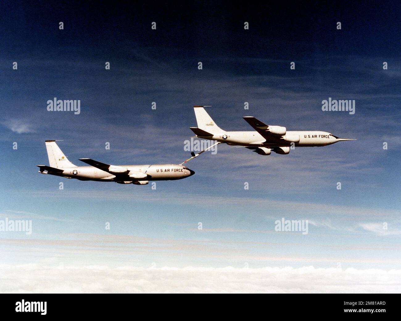 An aerial right side view of a KC-135R Stratotanker aircraft refueling a KC-135R Stratotanker ...