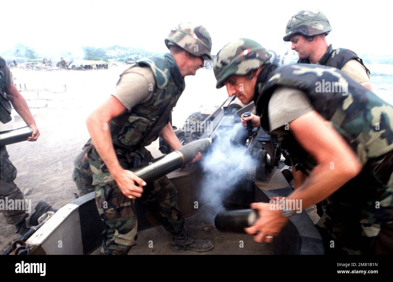 82nd Airborne artillery personnel load and fire M102 105 mm howitzers ...