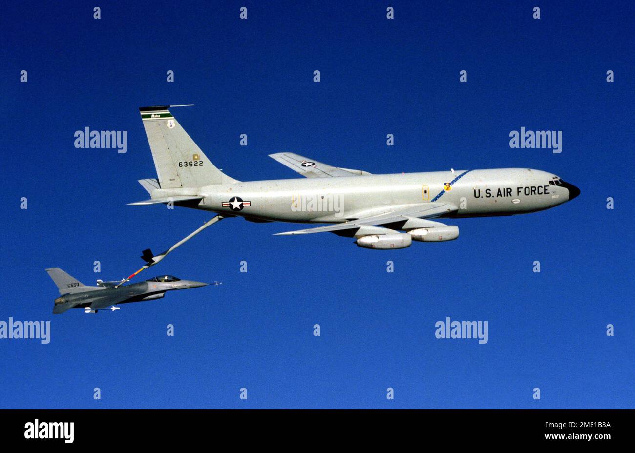 An air-to-air right side view of an F-16 Fighting Falcon aircraft, tail ...