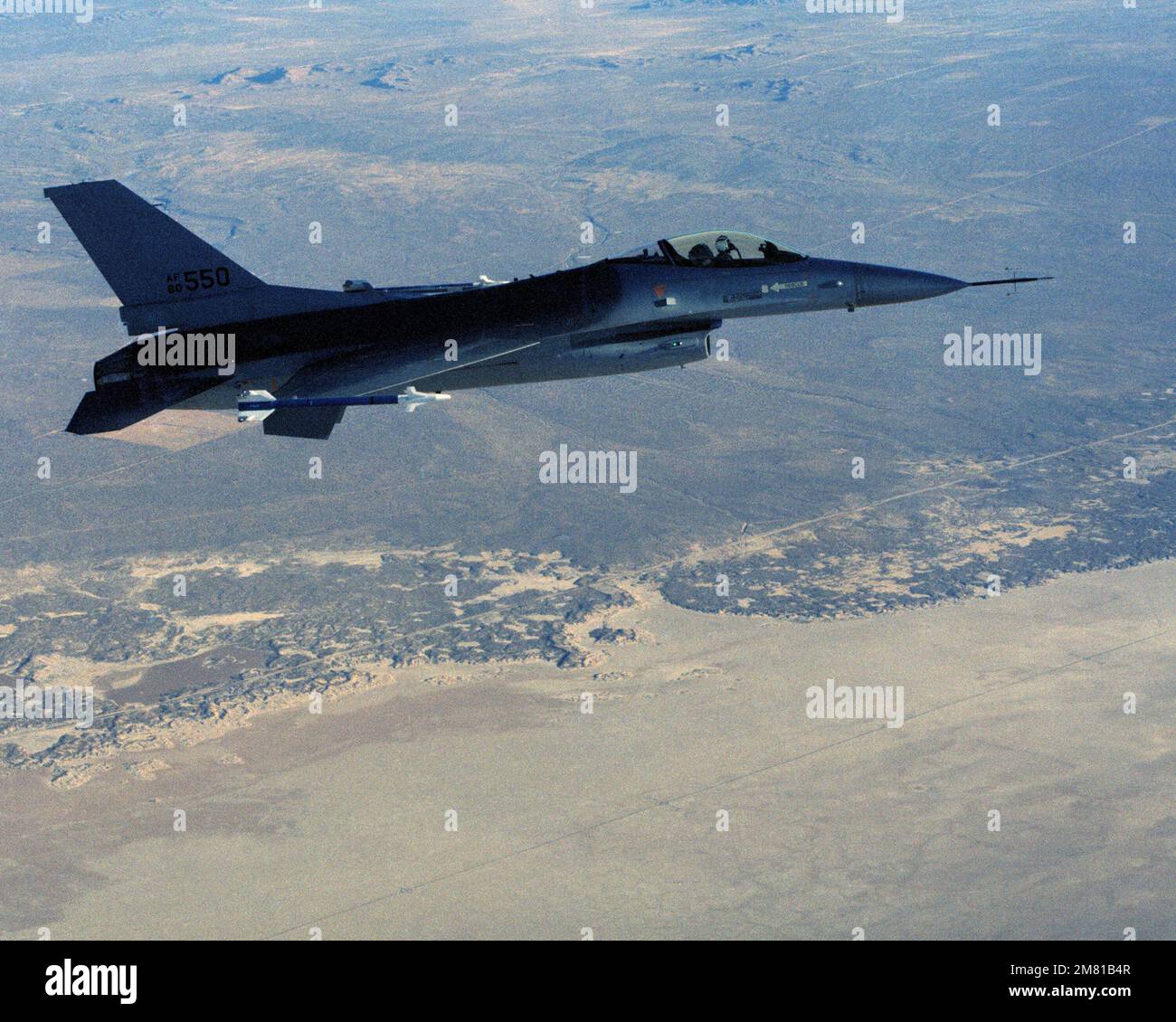 An air-to-air right side view of an F-16 Fighting Falcon aircraft ...
