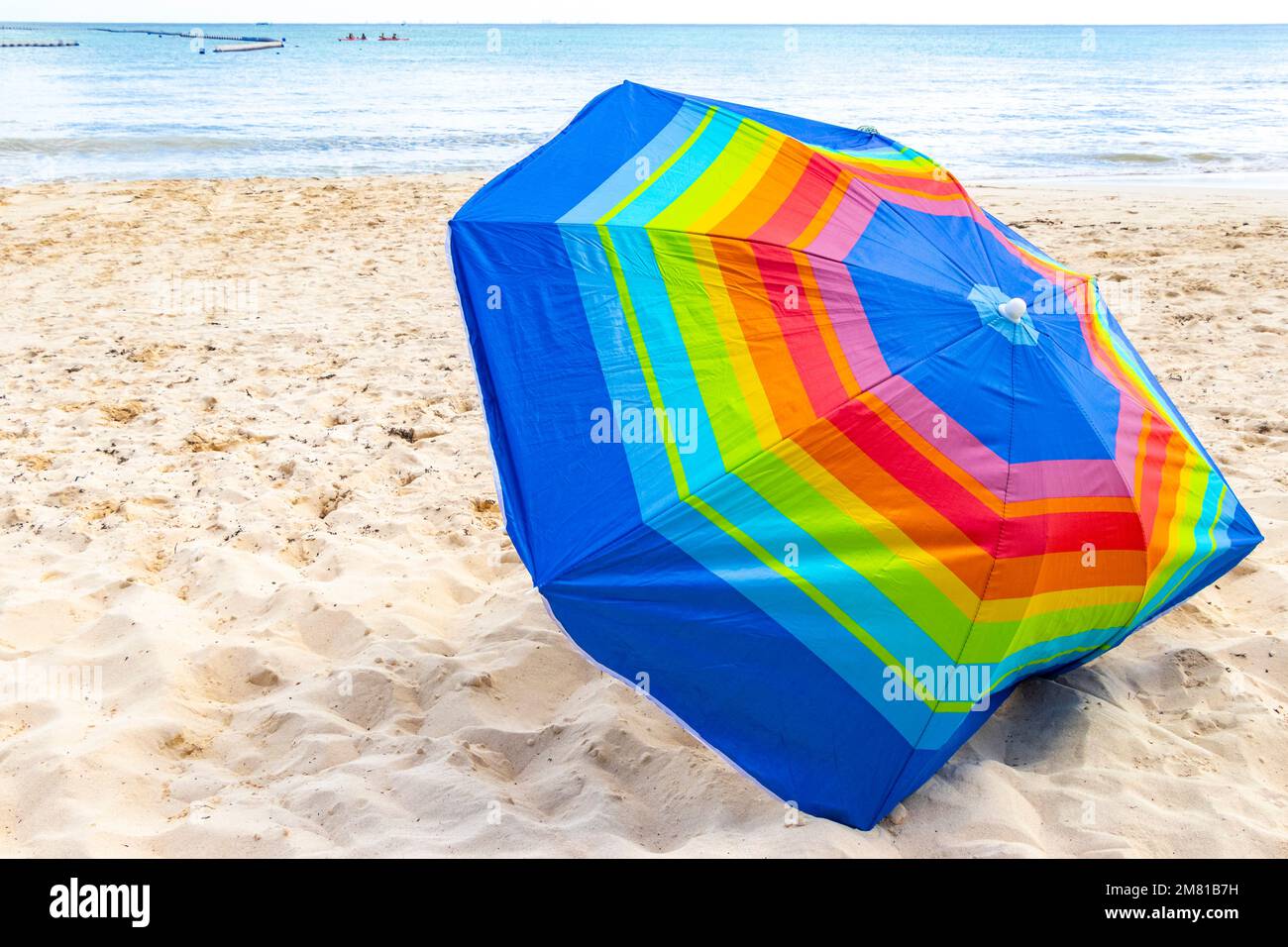Colorful parasol with many colors on the beach in Playa del Carmen ...