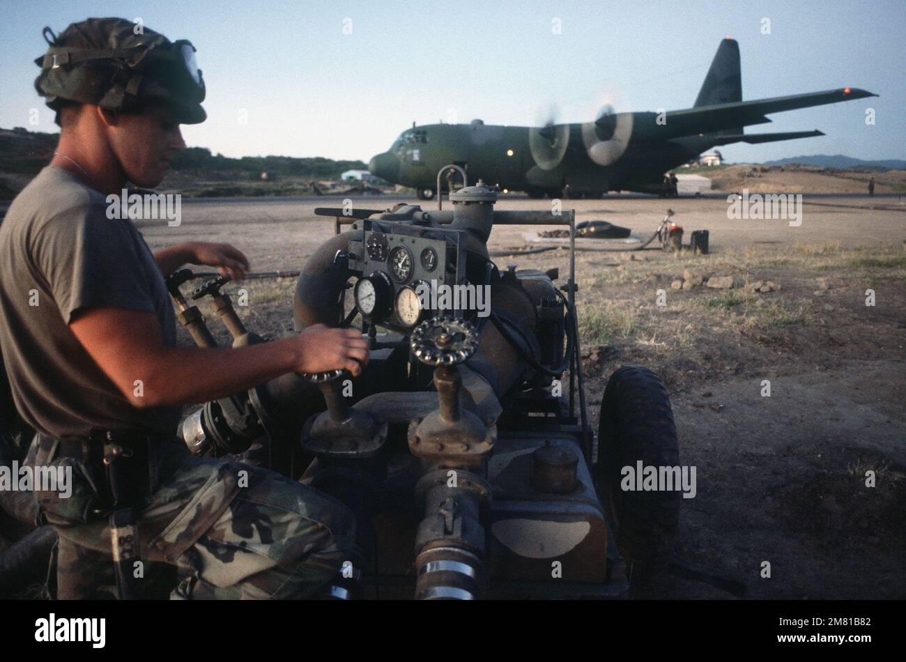 A member of the 82nd Airborne Division operates equipment to offload ...