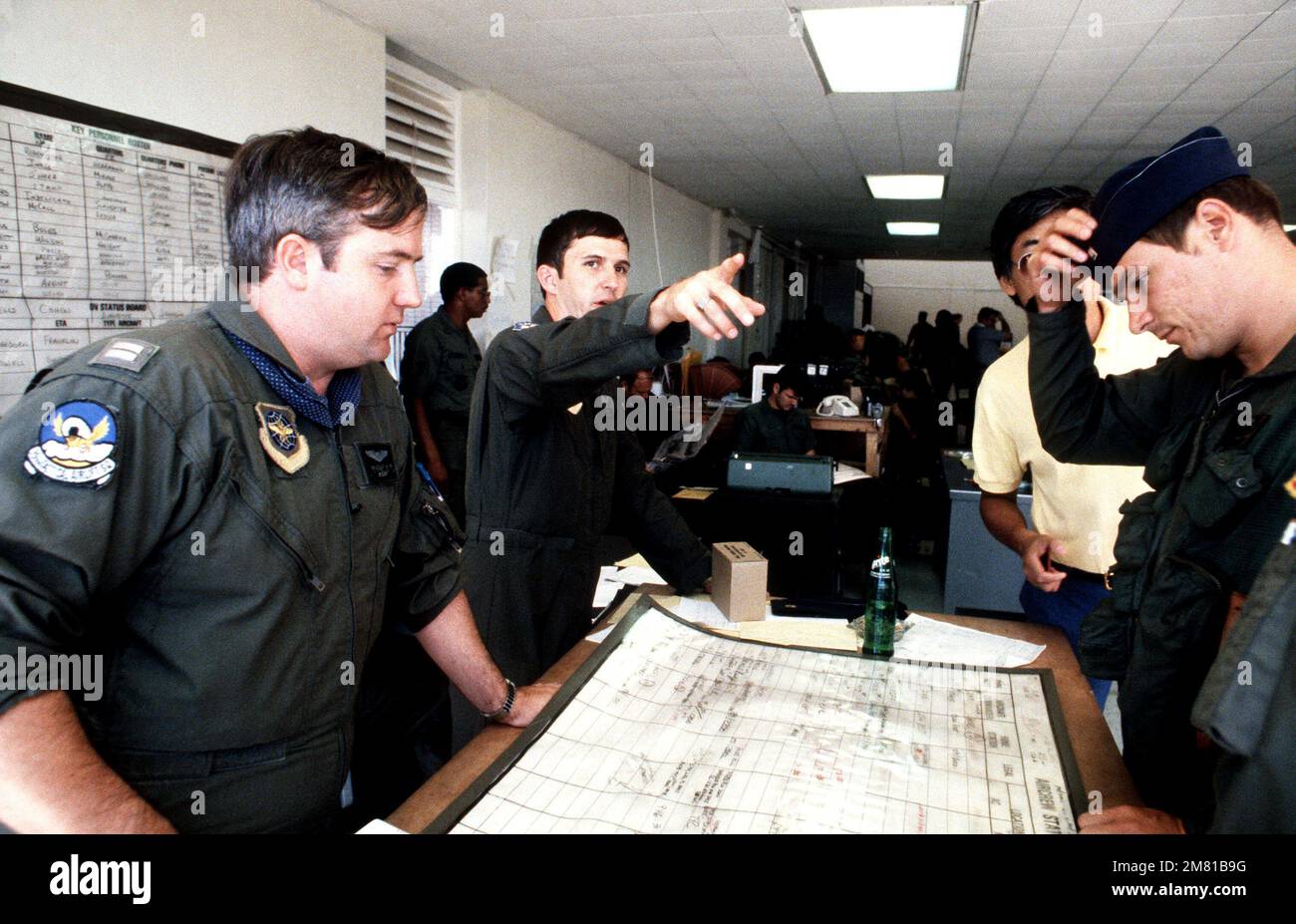 Air Force personnel study an air crew status board during Operation ...