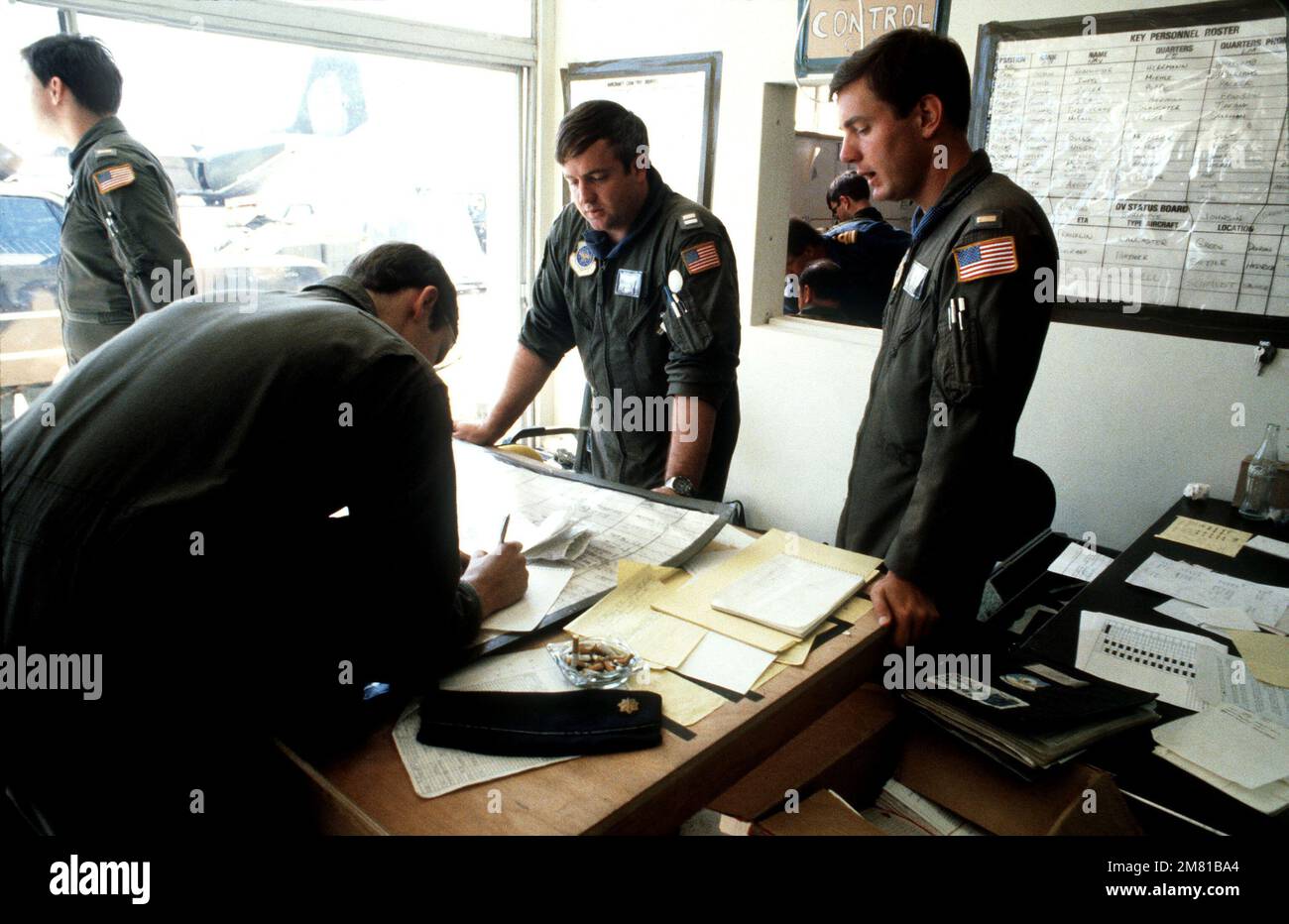 Air Force personnel study an air crew status board during Operation ...