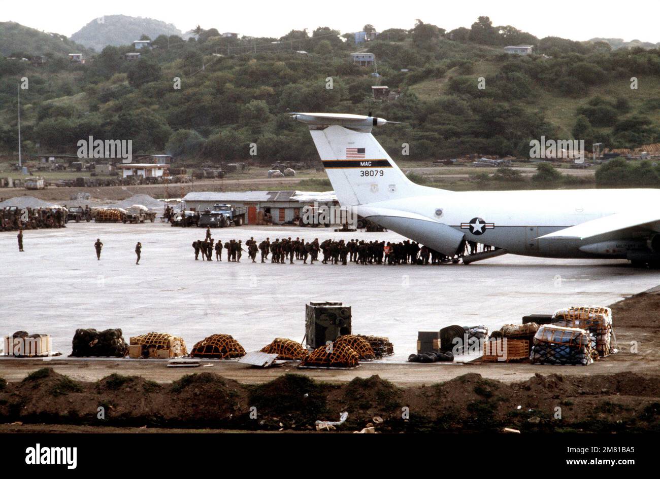 Members of the 82nd Airborne Division board a Military Airlift Command (MAC) C-141 Starlifter ...