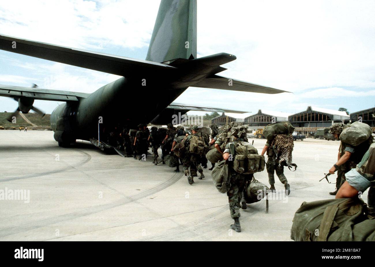 Members of the 82nd Airborne Division board a C-141B Starlifter aircraft during Operation URGENT ...