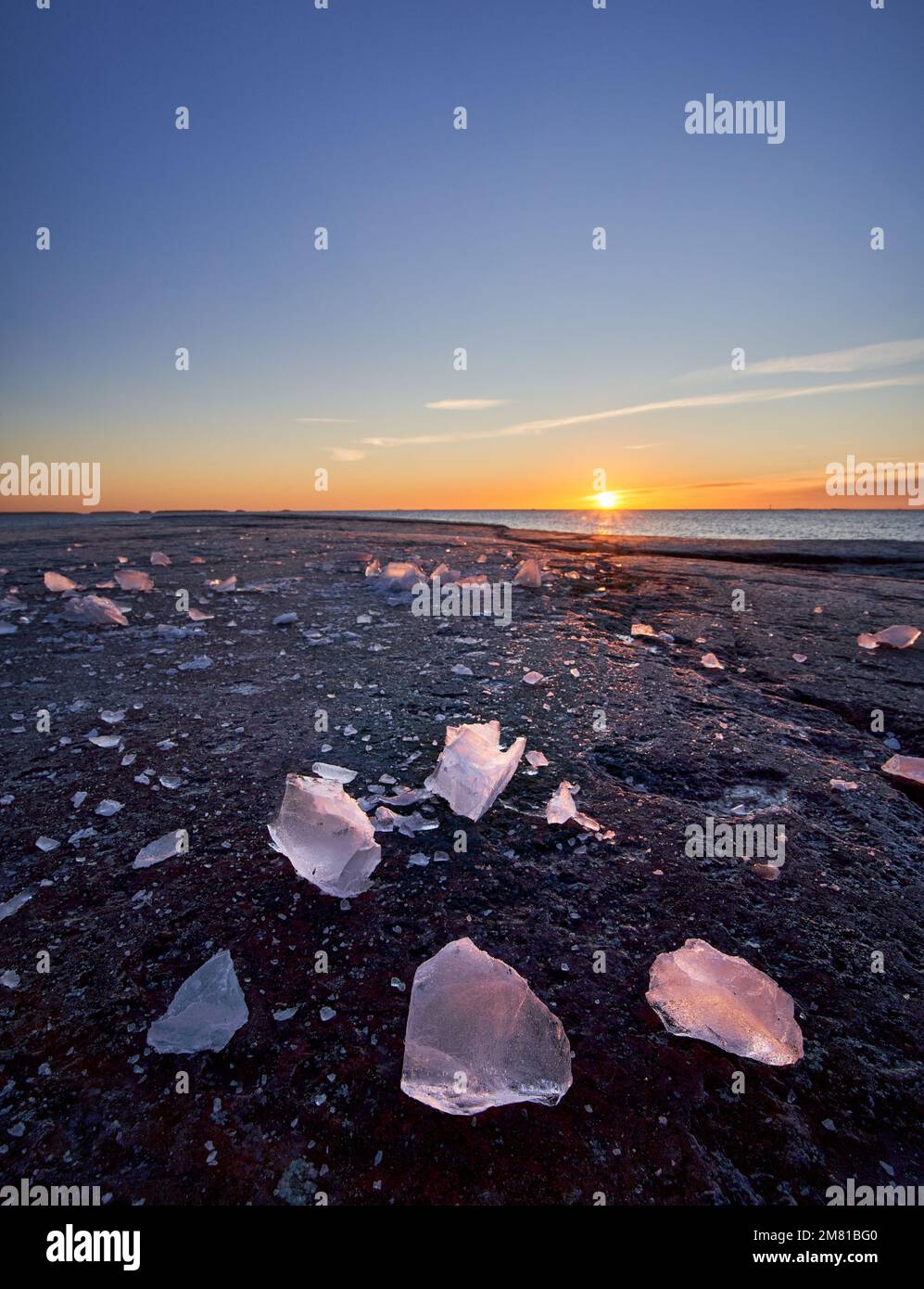 A vertical shot of quartz minerals on the shore of the sea during a ...
