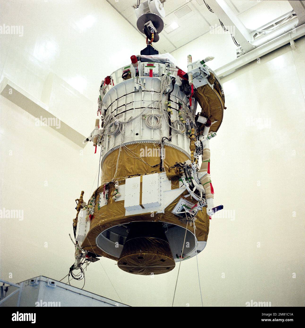 An Inertial Upper Stage (IUS) is transferred to a transporter in the ...