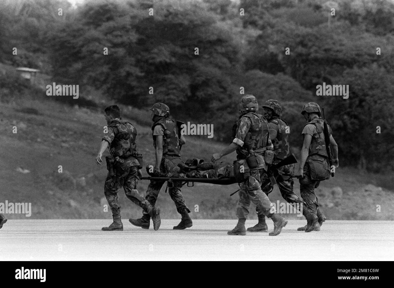 A wounded soldier is carried toward a C-141B Starlifter aircraft for ...
