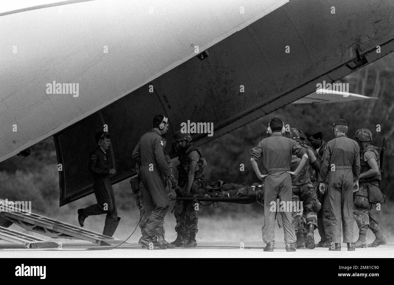 A wounded soldier is carried aboard a C-141B Starlifter aircraft for ...