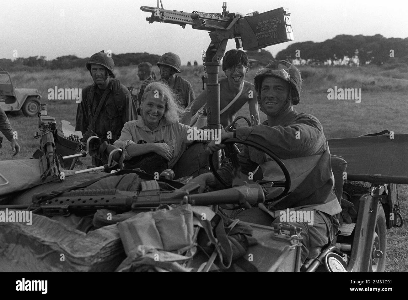 An American woman sits in the front seat of an M151A1 1/4-ton light ...