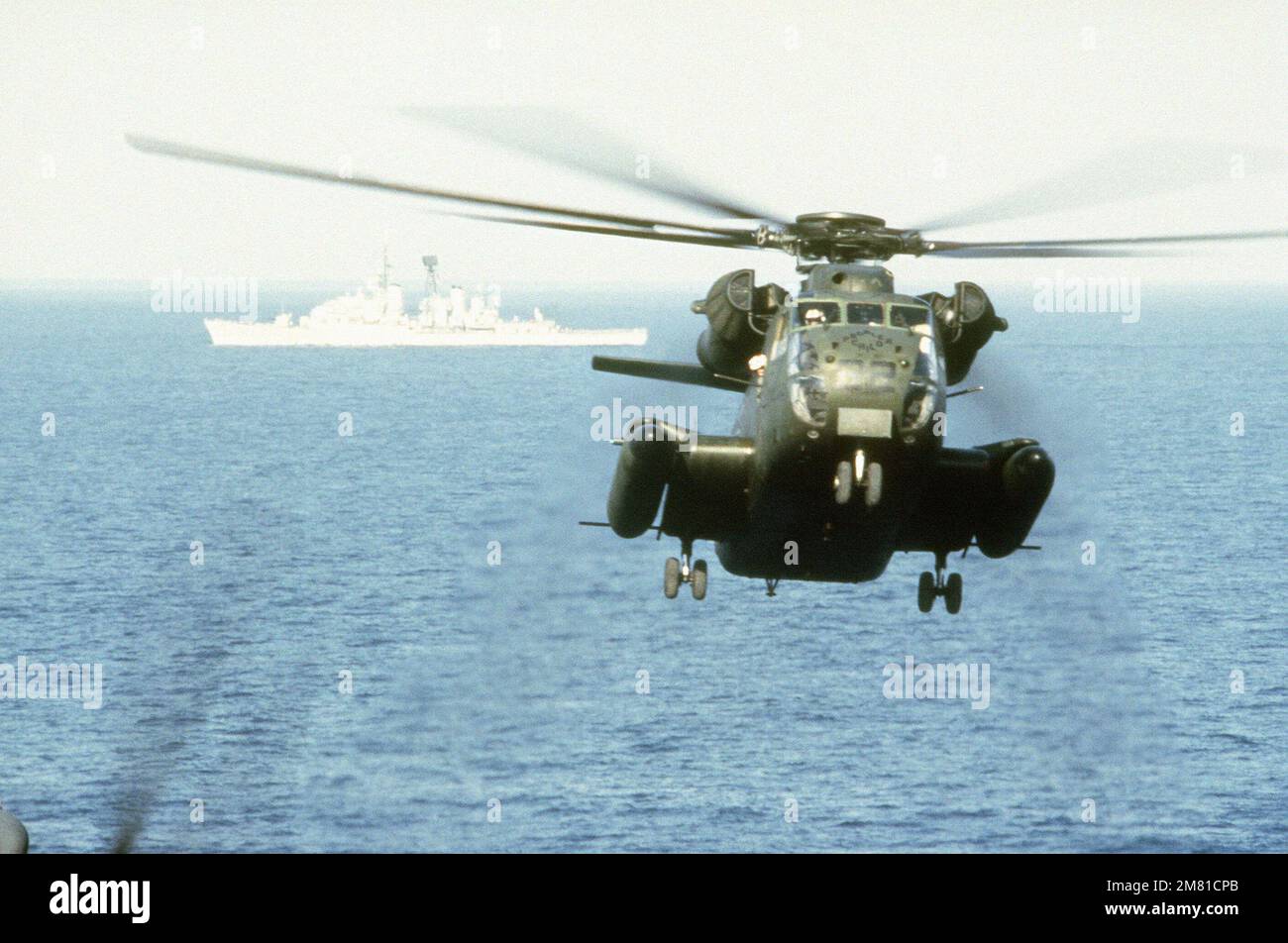 A CH-53 Sea Stallion helicopter approaches for a landing on the flight ...
