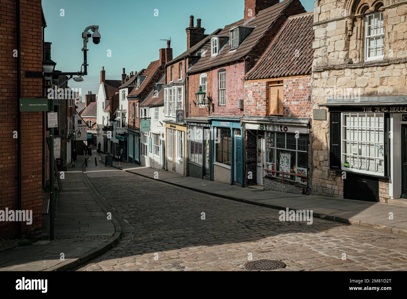 A quaint row of shops line a cobbled road known as The Strait, at the ...
