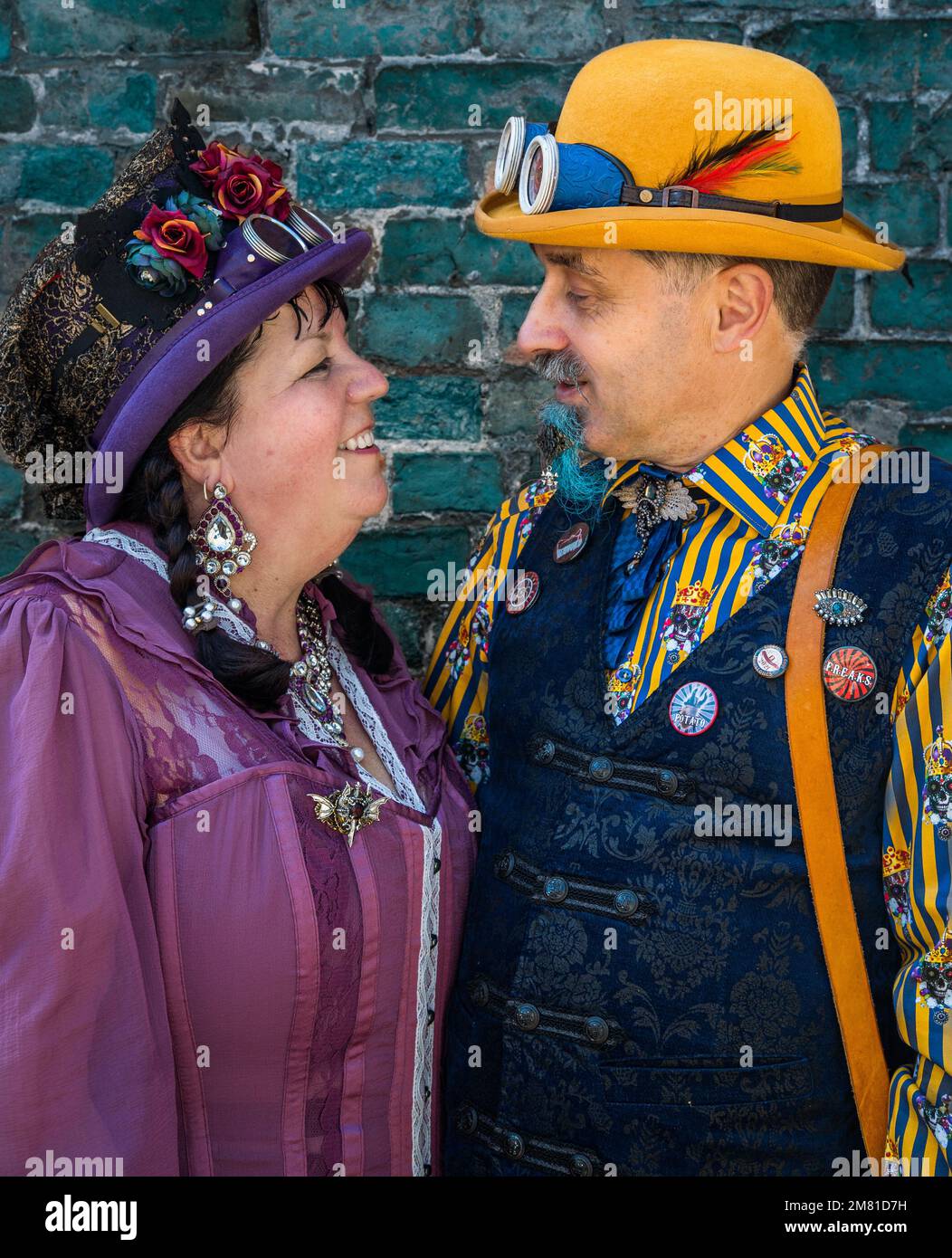 Portrait of a male and female steampunk looking into each others eyes ...