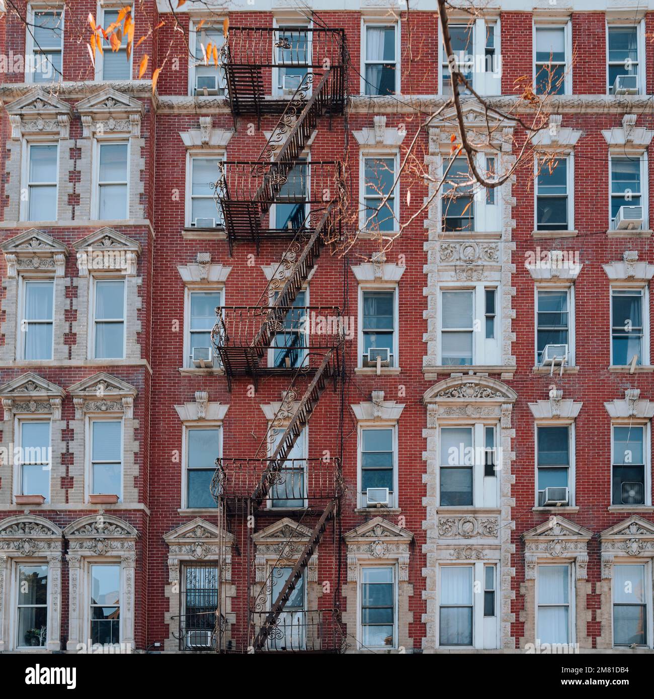 Facade of typical New York apartment blocks with fire escape at the ...