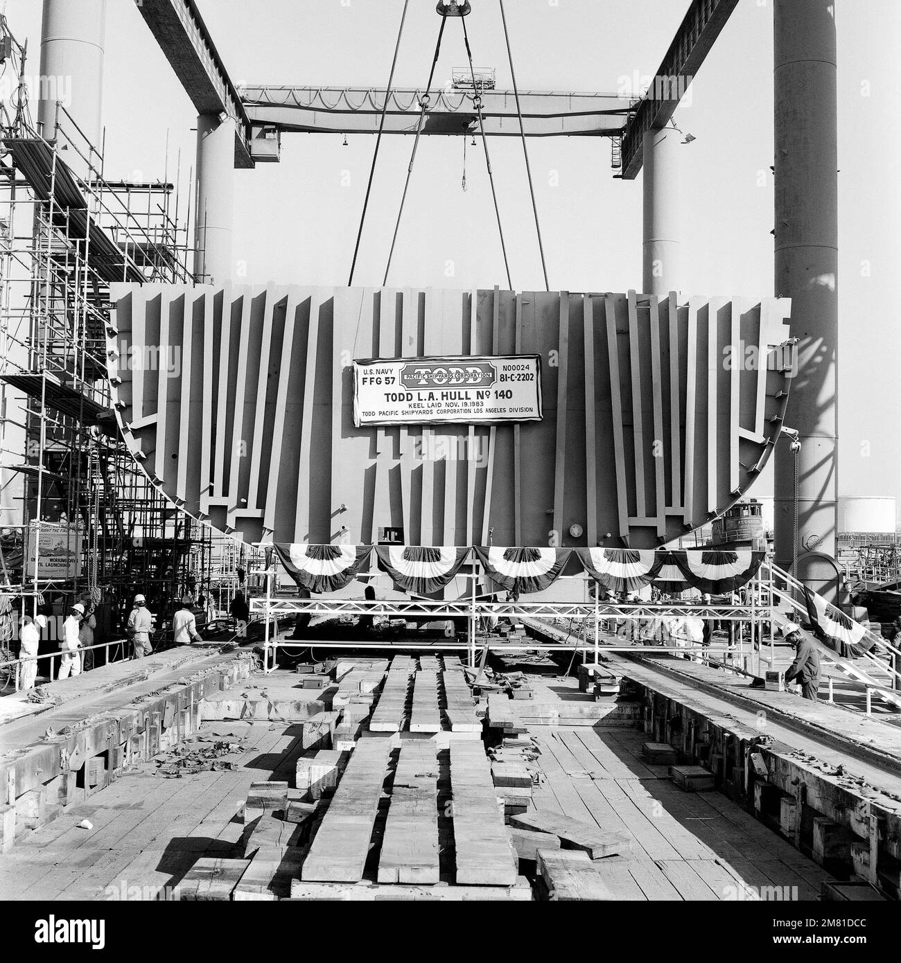 Workmen lay the keel of the Oliver Hazard Perry-class guided missile ...