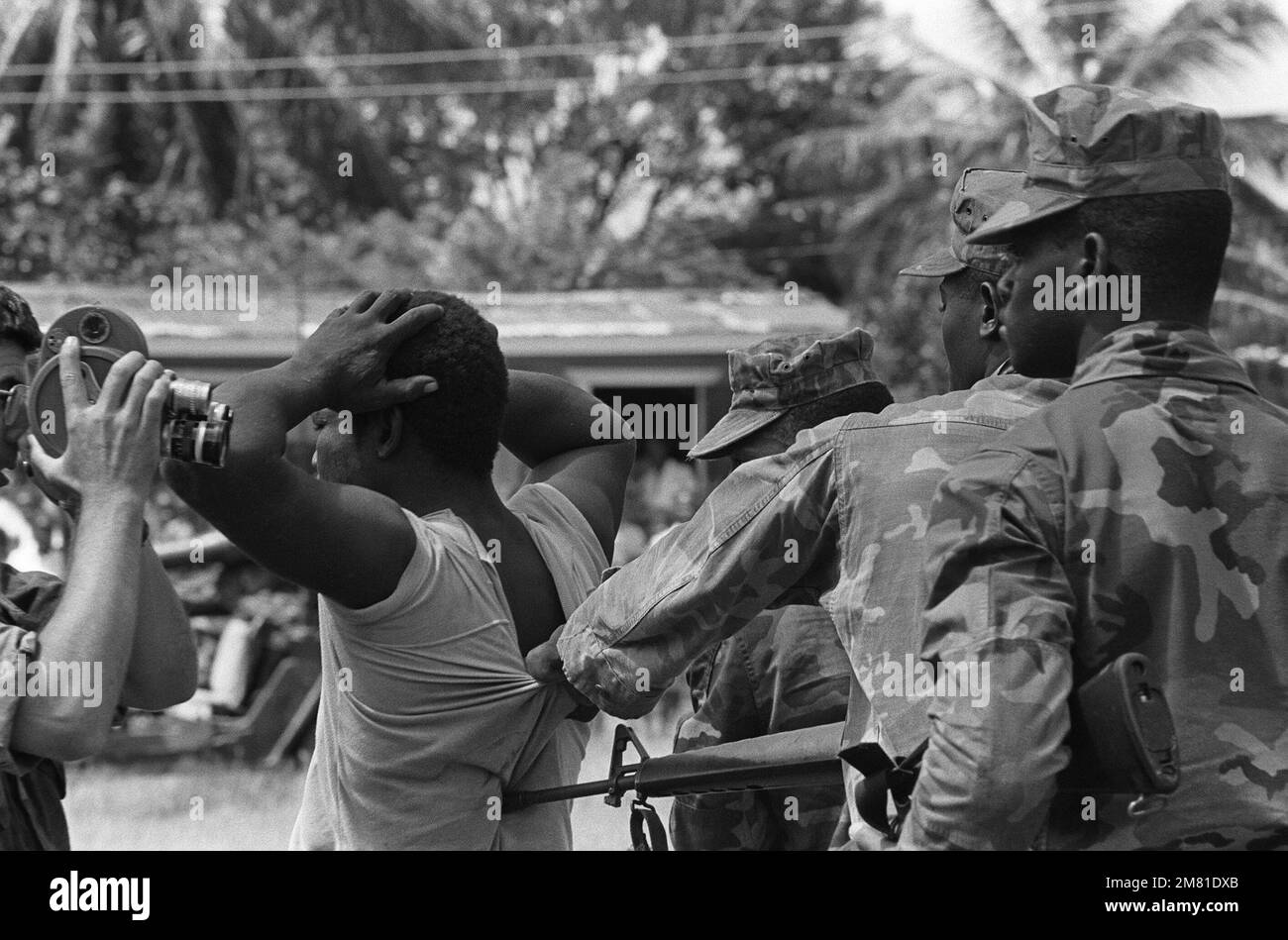 A member of the Peoples Revolutionary Army is searched by Marines after ...