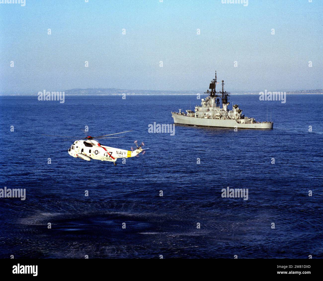 An air-to-air left side view of an SH-3 Sea King helicopter from ...