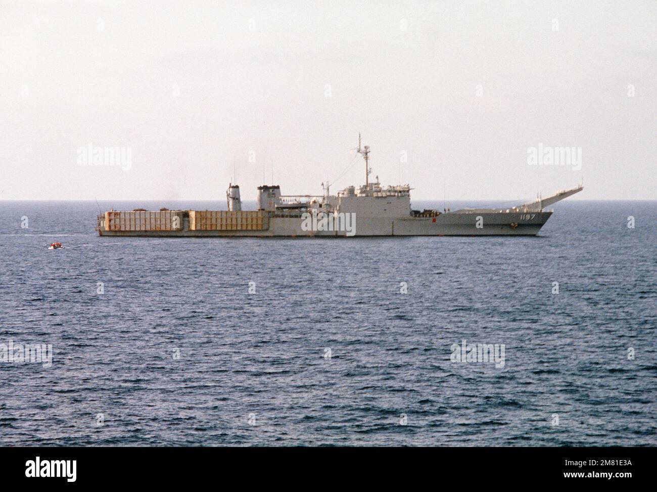A starboard beam view of the tank landing ship USS BARNSTABLE COUNTY ...