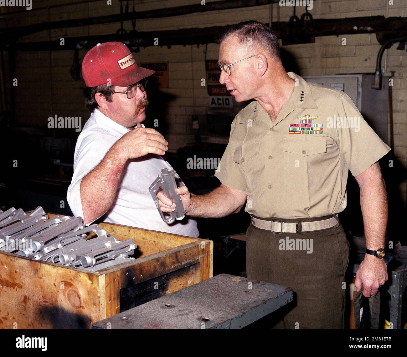 W. T. Milligan, electroplater, Small Arms Section, explains the ...