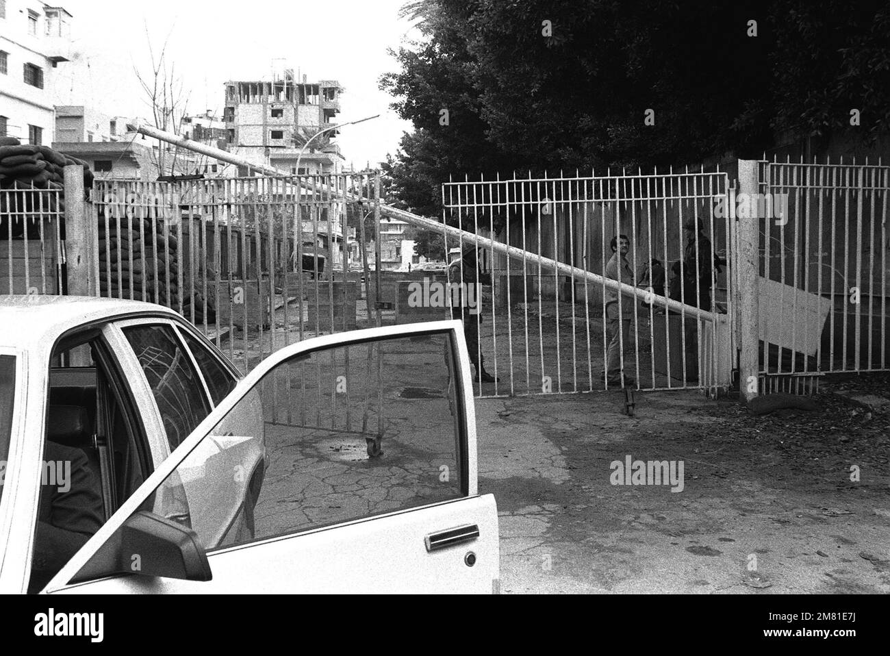 Marines talk with a US Embassy employee outside the Embassy gate during ...
