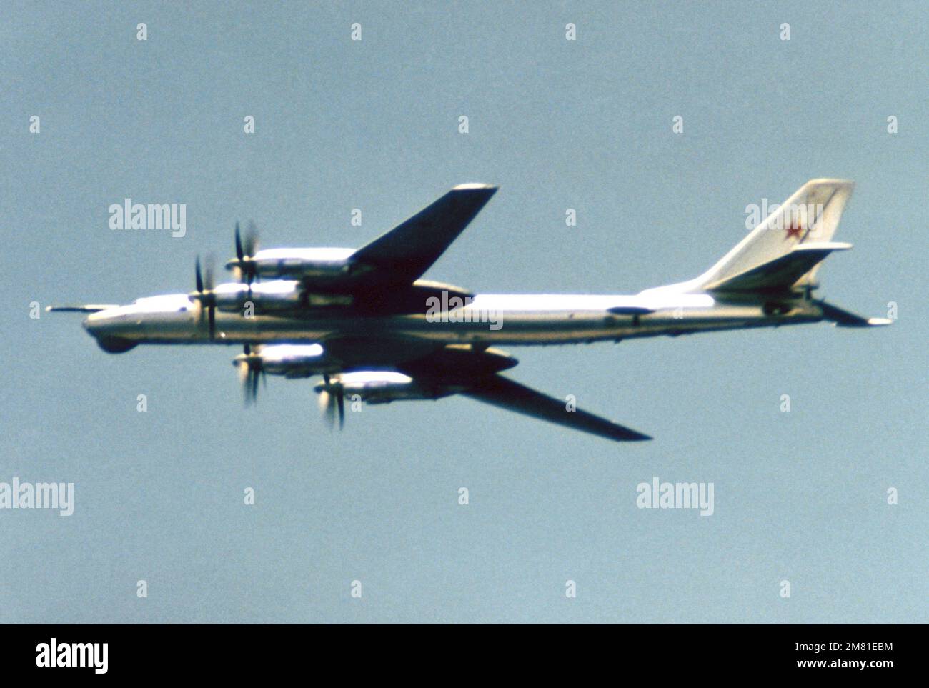 Left side view of a Tu-142 Bear-D aircraft in flight off the coast of ...