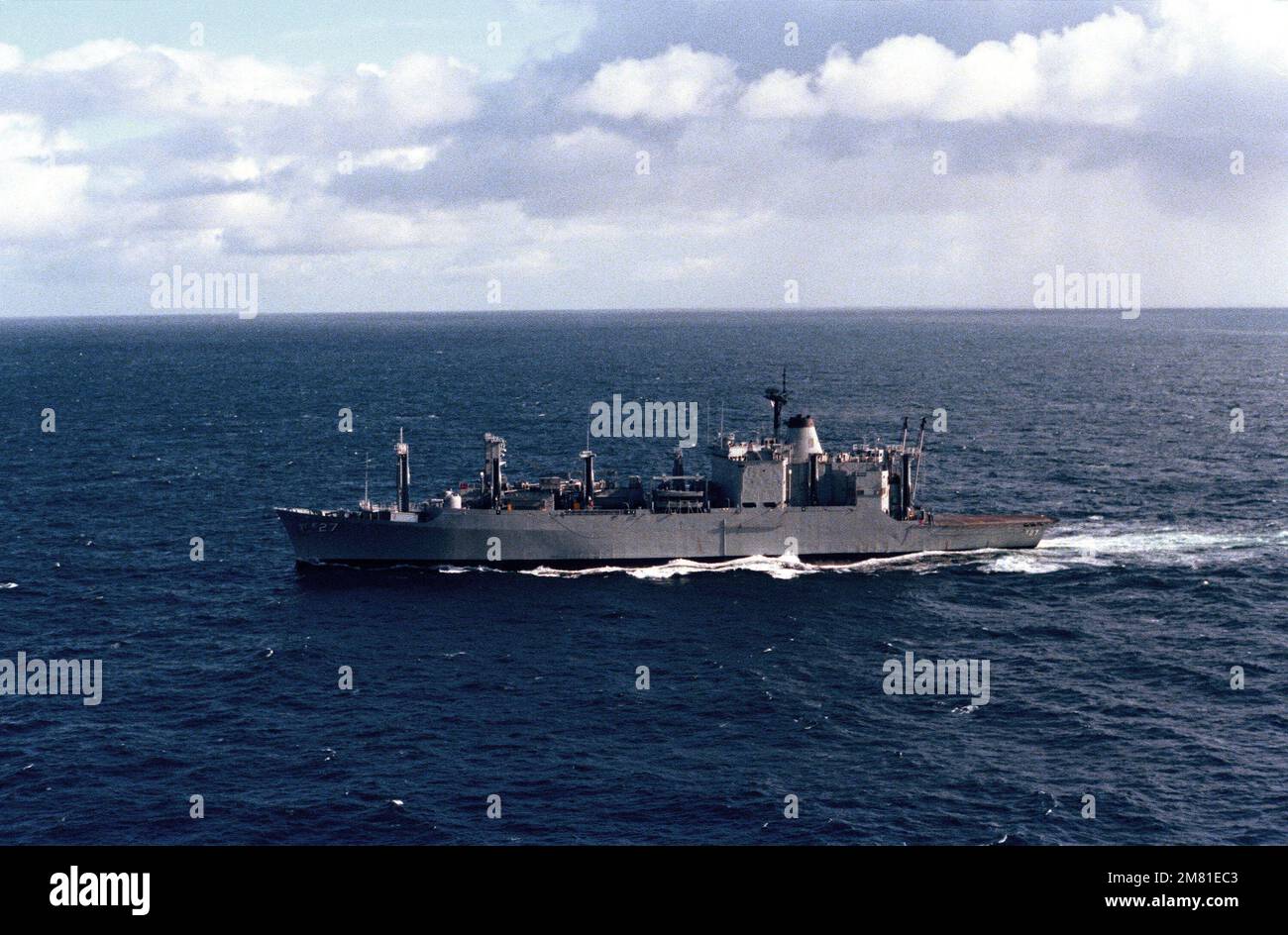 An aerial port beam view of the ammunition ship USS BUTTE (AE 27 ...