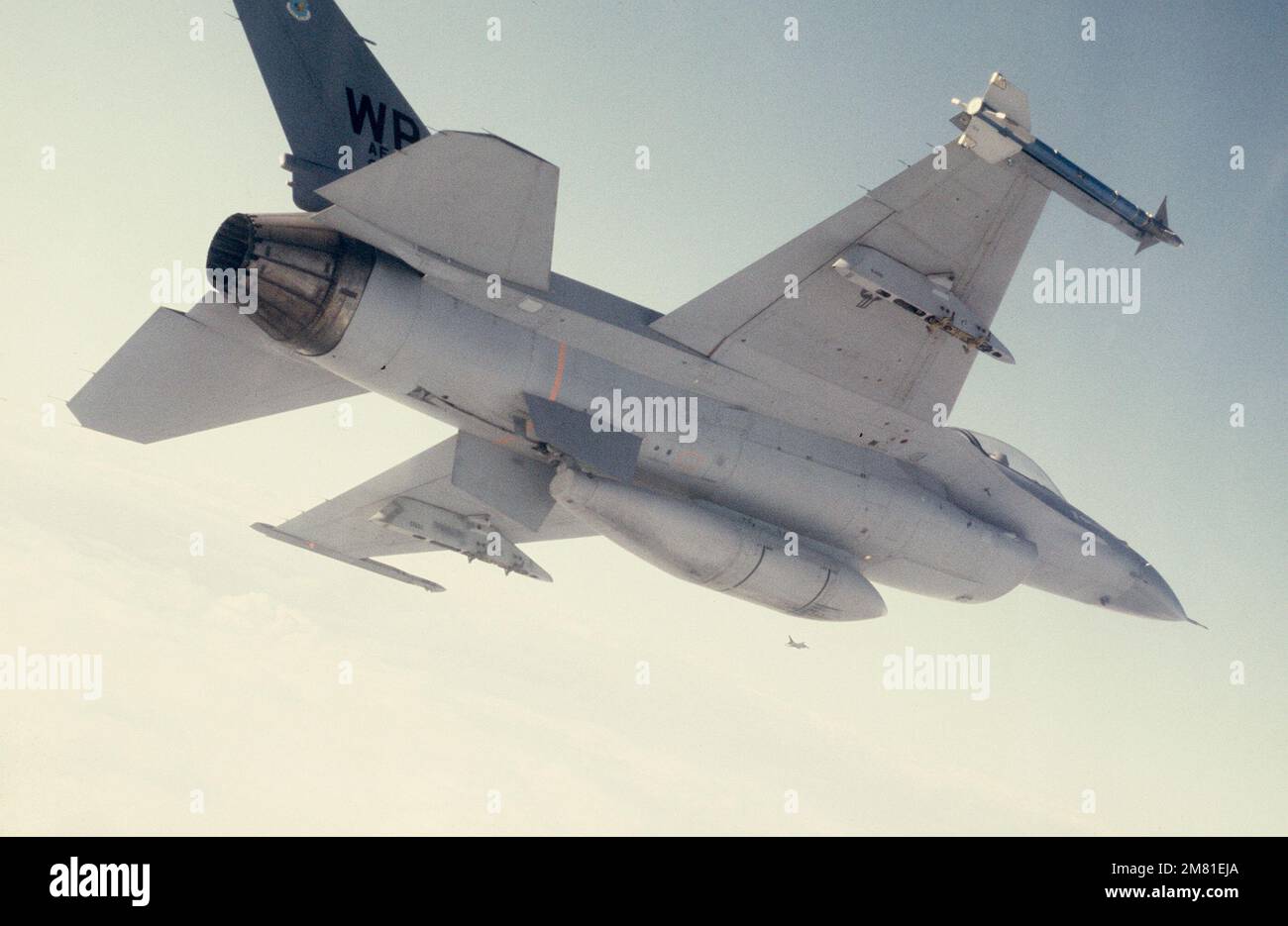 An air-to-air right underside view of an F-16 Fighting Falcon aircraft ...