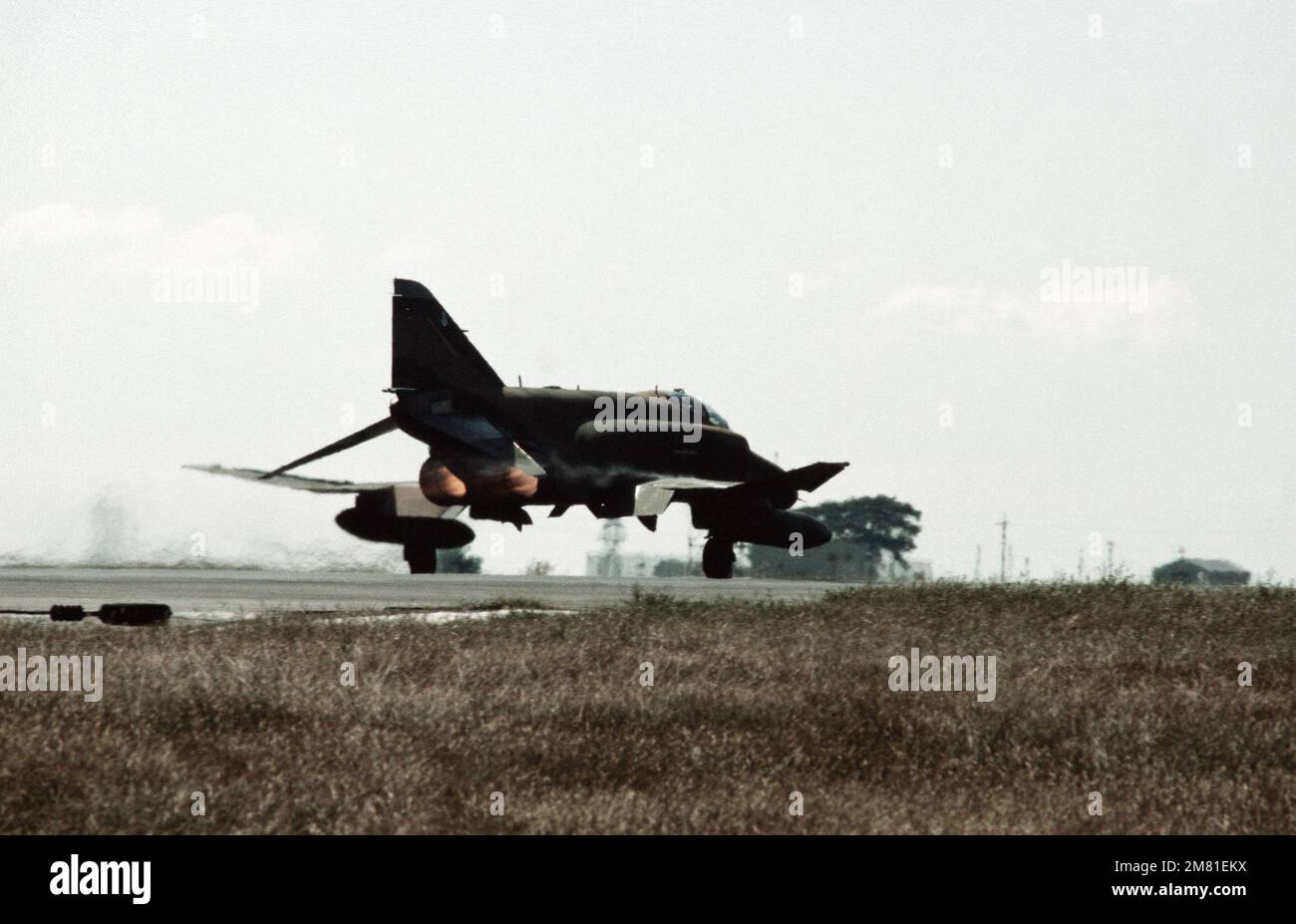 An F-4 Phantom II aircraft on the runway just prior to takeoff, during ...