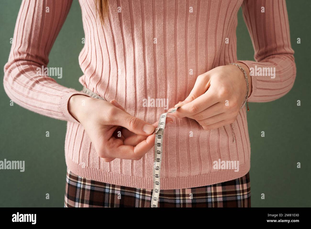 Teenage girl measuring her waist Stock Photo - Alamy