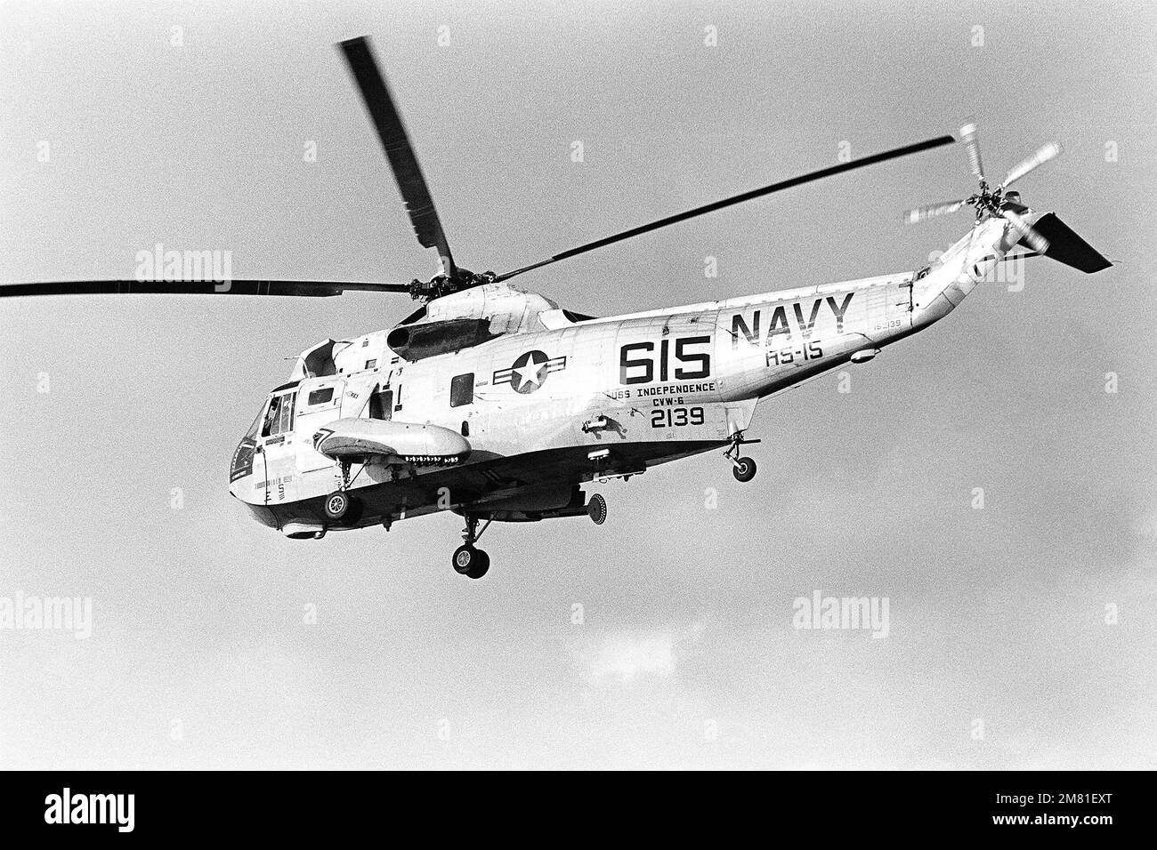 An SH-3D Sea King helicopter hovers above the aircraft carrier USS ...