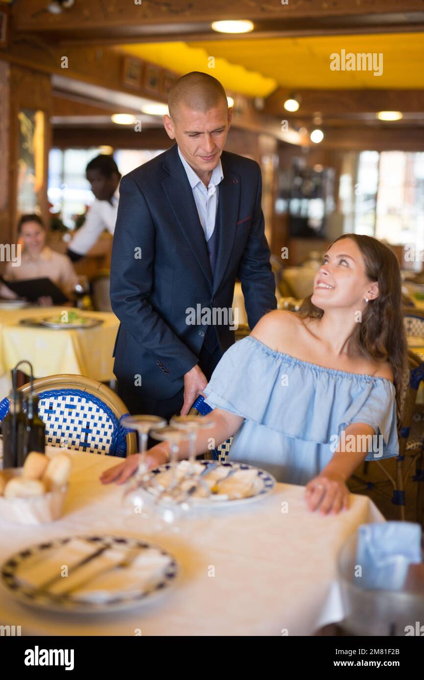 Portrait of a young elegant couple visiting restaurant Stock Photo - Alamy