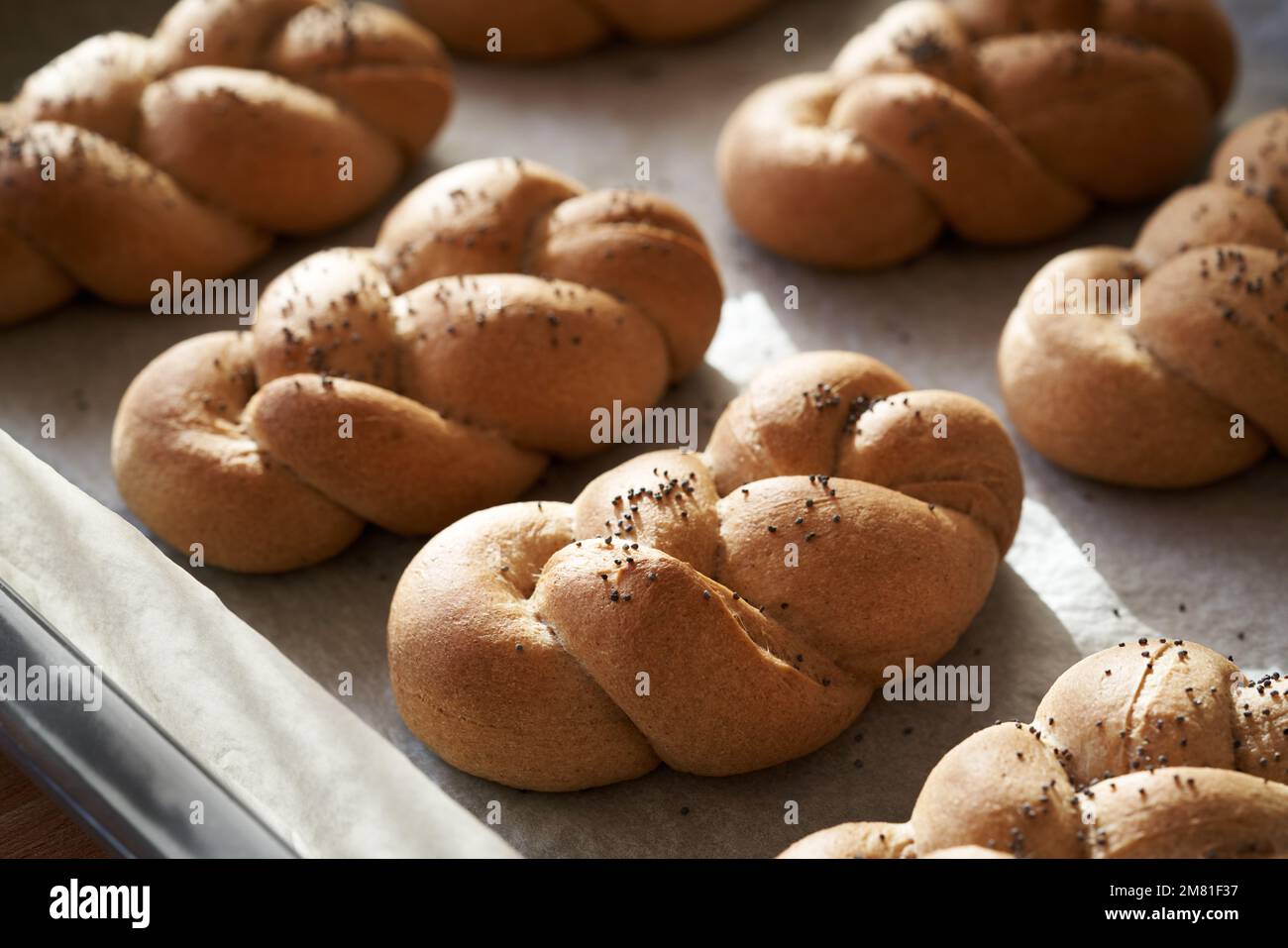 Braided bread rolls or buns made from whole grain spelt flour on a ...