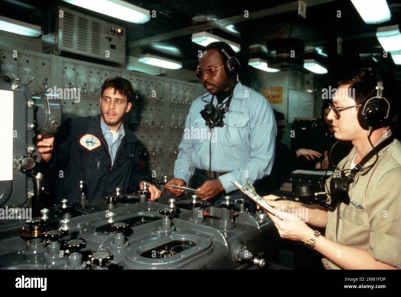 Reserve SEAMAN (SN) Clarence Christie, center, stands watch as a ...