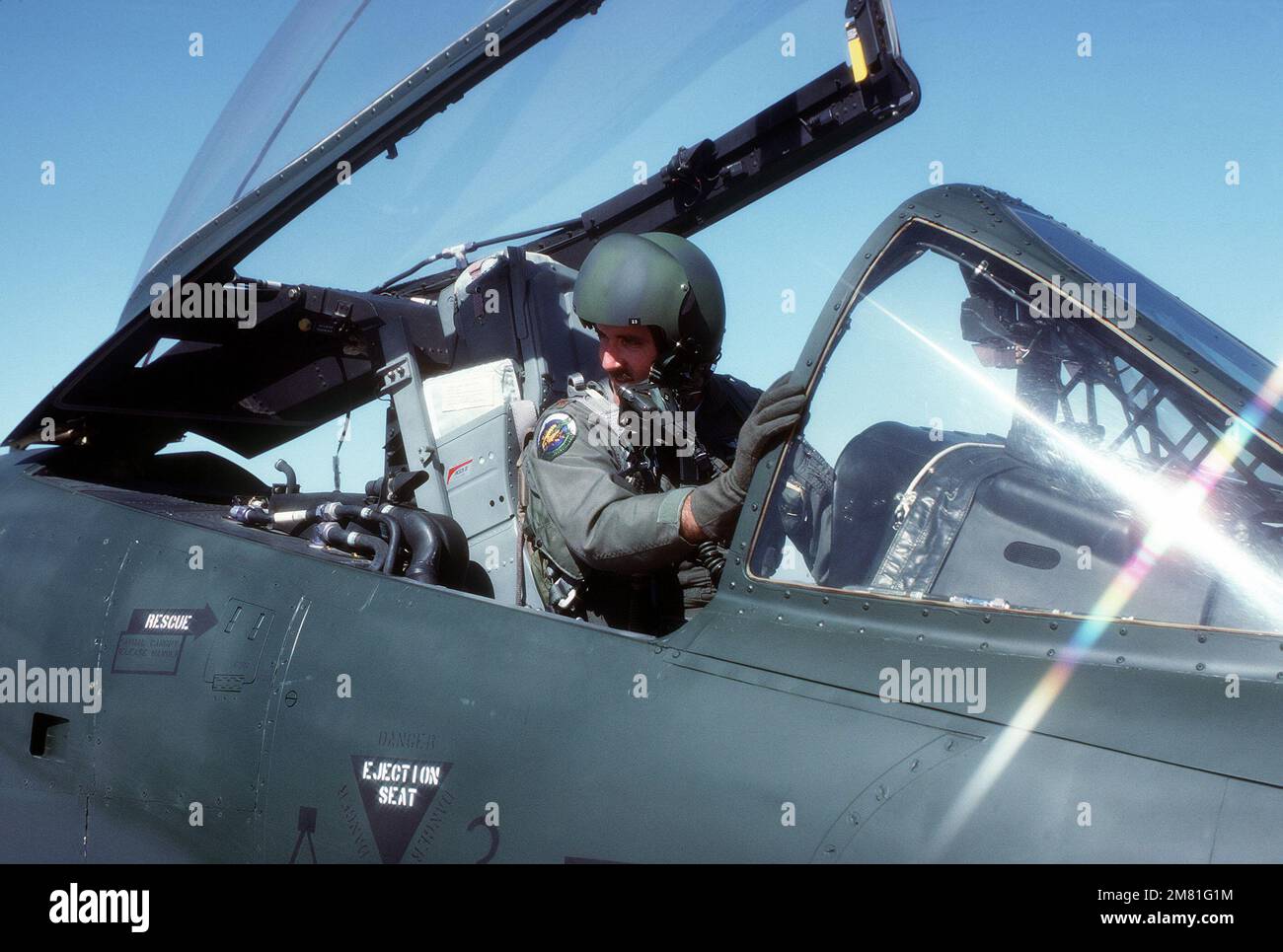 A pilot settles into the cockpit of an A-10 Thunderbolt II aircraft ...