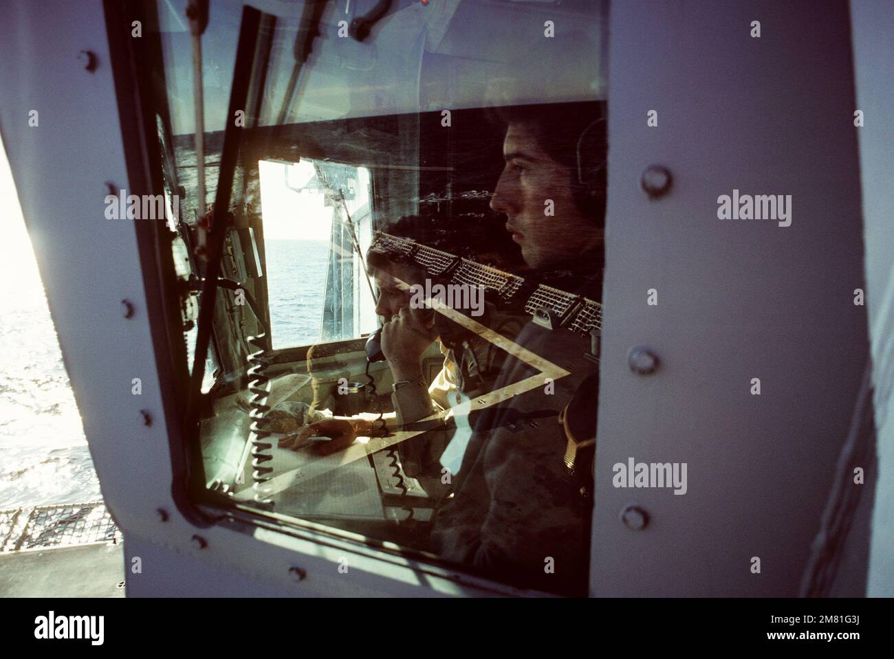 Crewmen observe from a control booth as the Navy's first operational ...