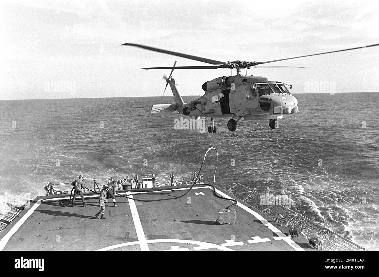 An in-flight refueling line is hoisted up by the Navy's first ...