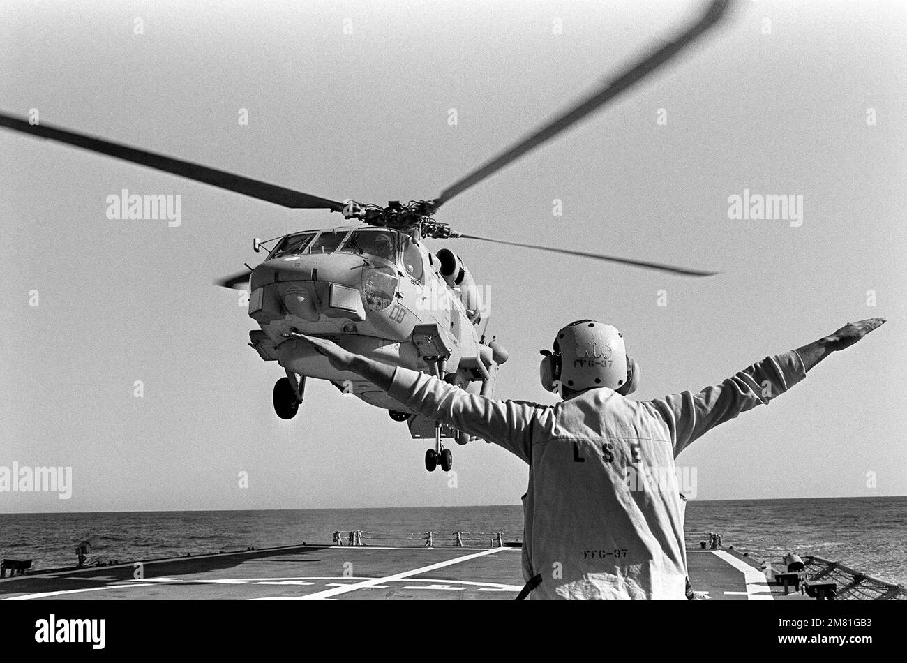A plane director guides the first operational Mark III LAMPS (Light ...