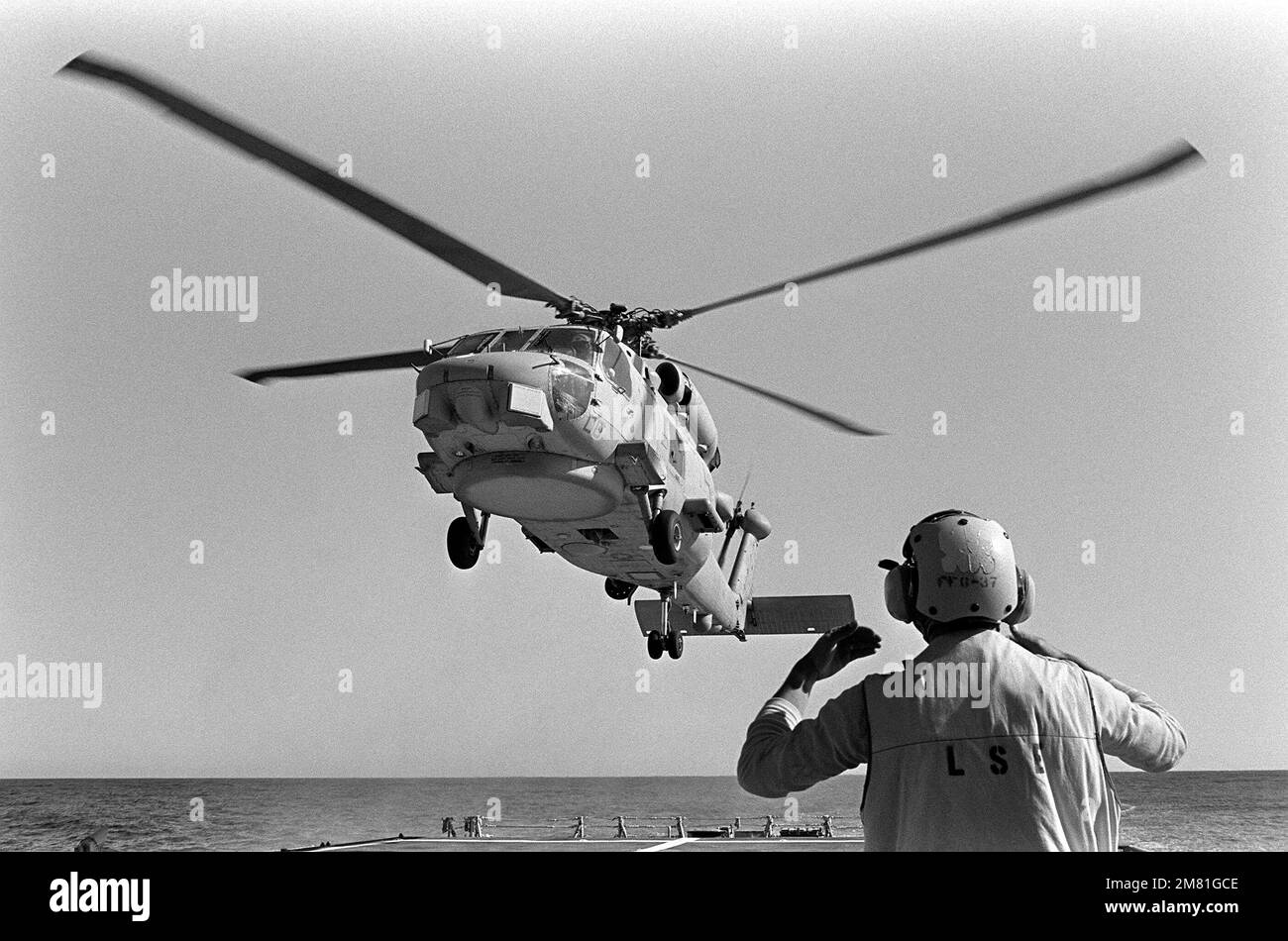 A plane director guides the first operational Mark III LAMPS (Light ...