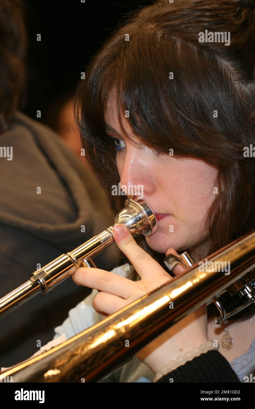 A young student trombonist playing a rehearsal piece for CoMA ...