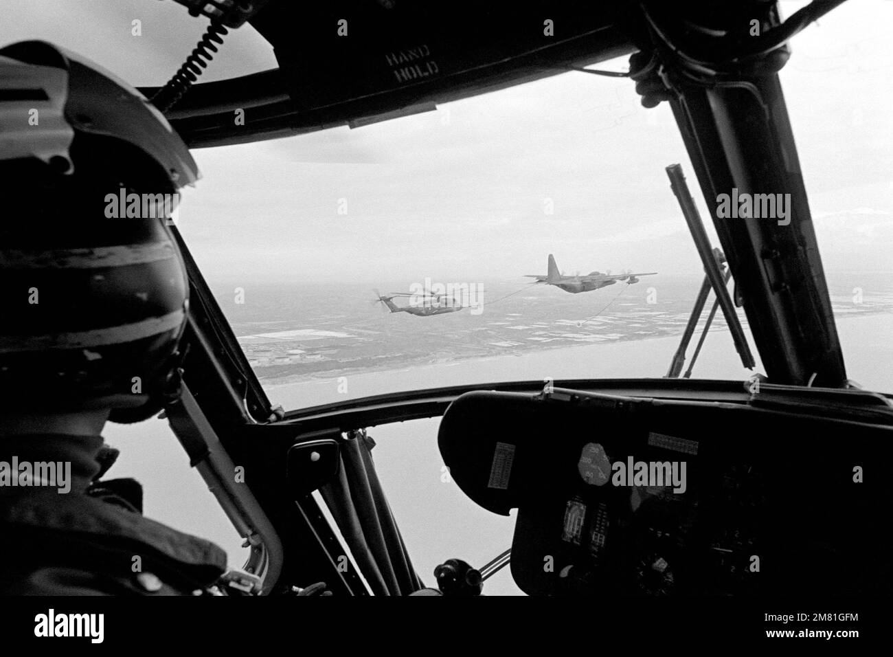 A view looking out of the cockpit of an aircraft, as a CH-53 Sea ...