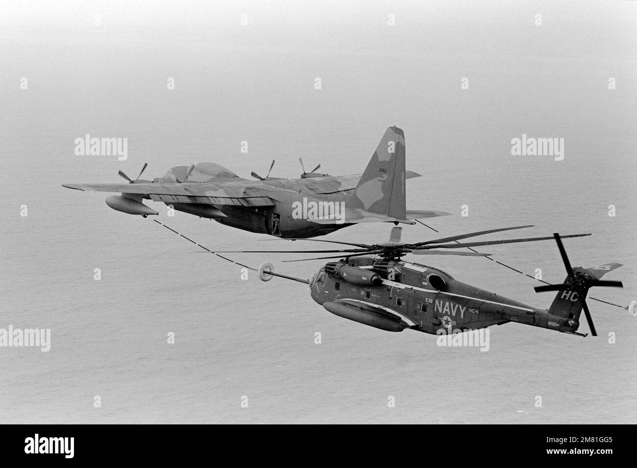 An air-to-air view of a CH-53 Sea Stallion helicopter during refueling ...
