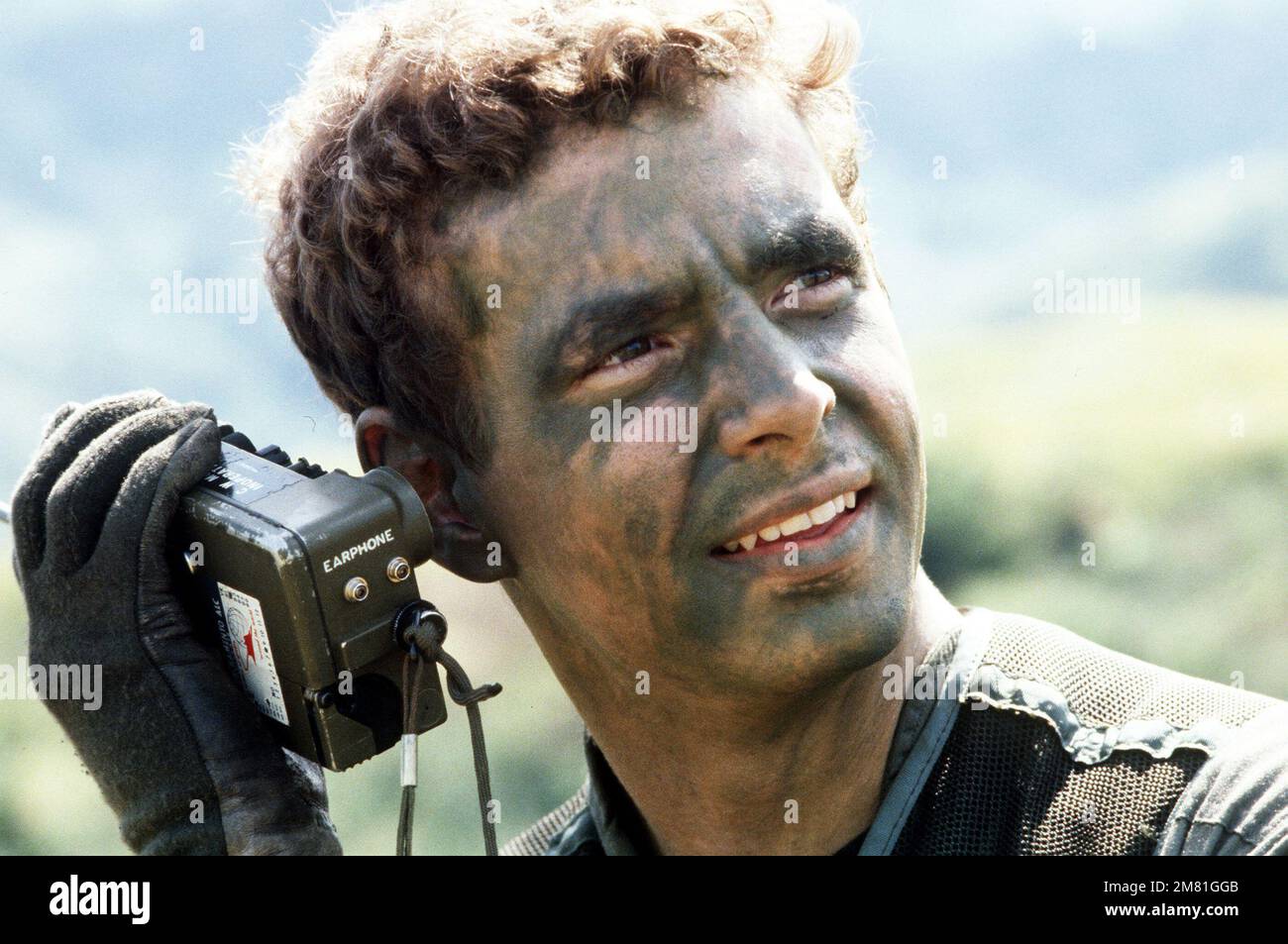 A "survivor" uses a radio to contact a rescue helicopter during ...