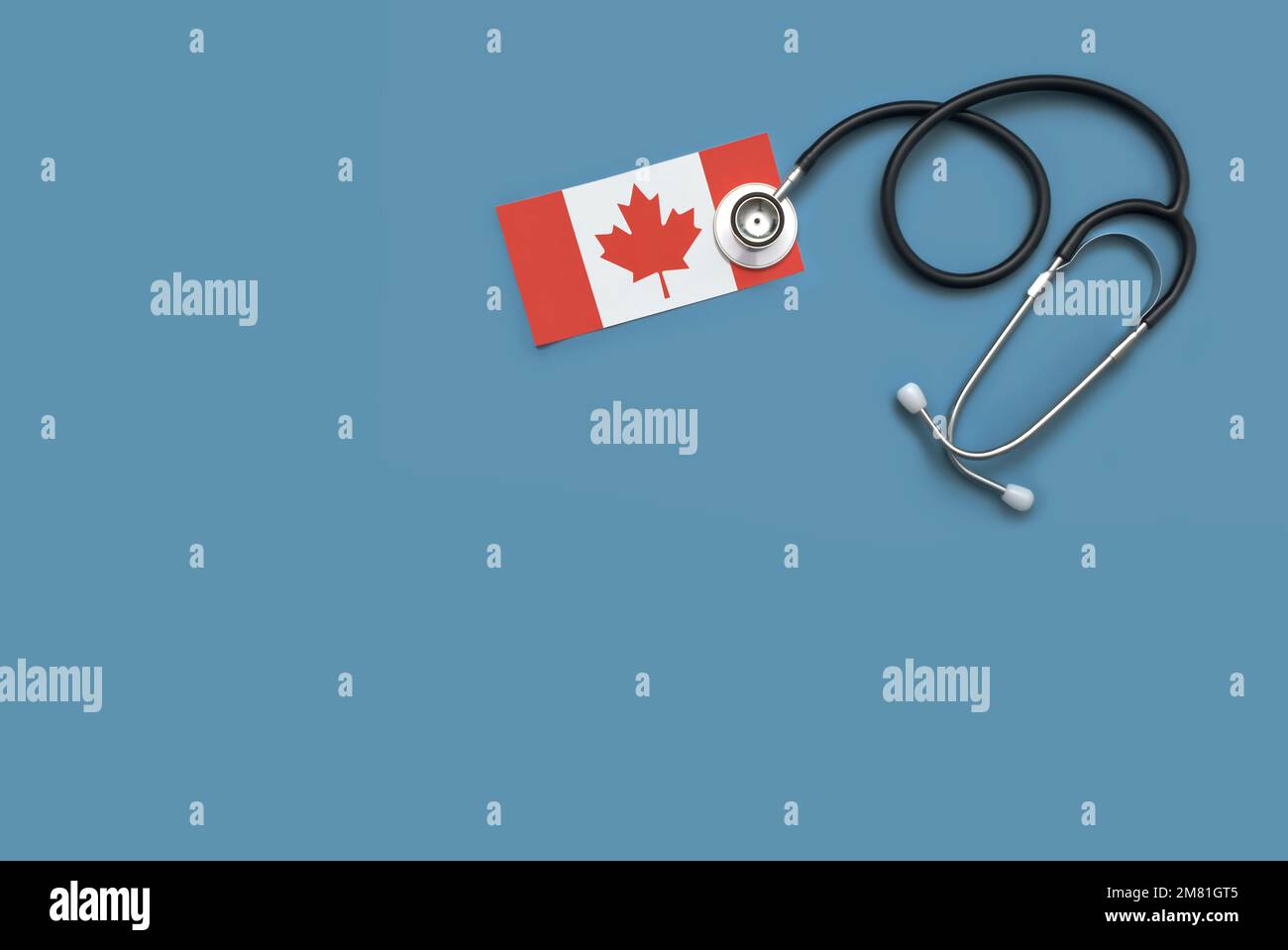 Overhead flat lay of a doctor's stethoscope with the Canadian flag ...