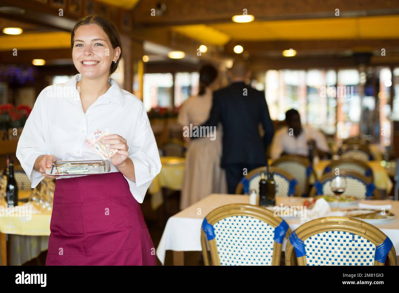 Waitress satisfied with good tip from guests Stock Photo - Alamy