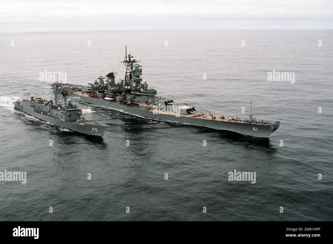 An elevated starboard bow view of the battleship USS IOWA (BB-61) refueling the guided missile ...