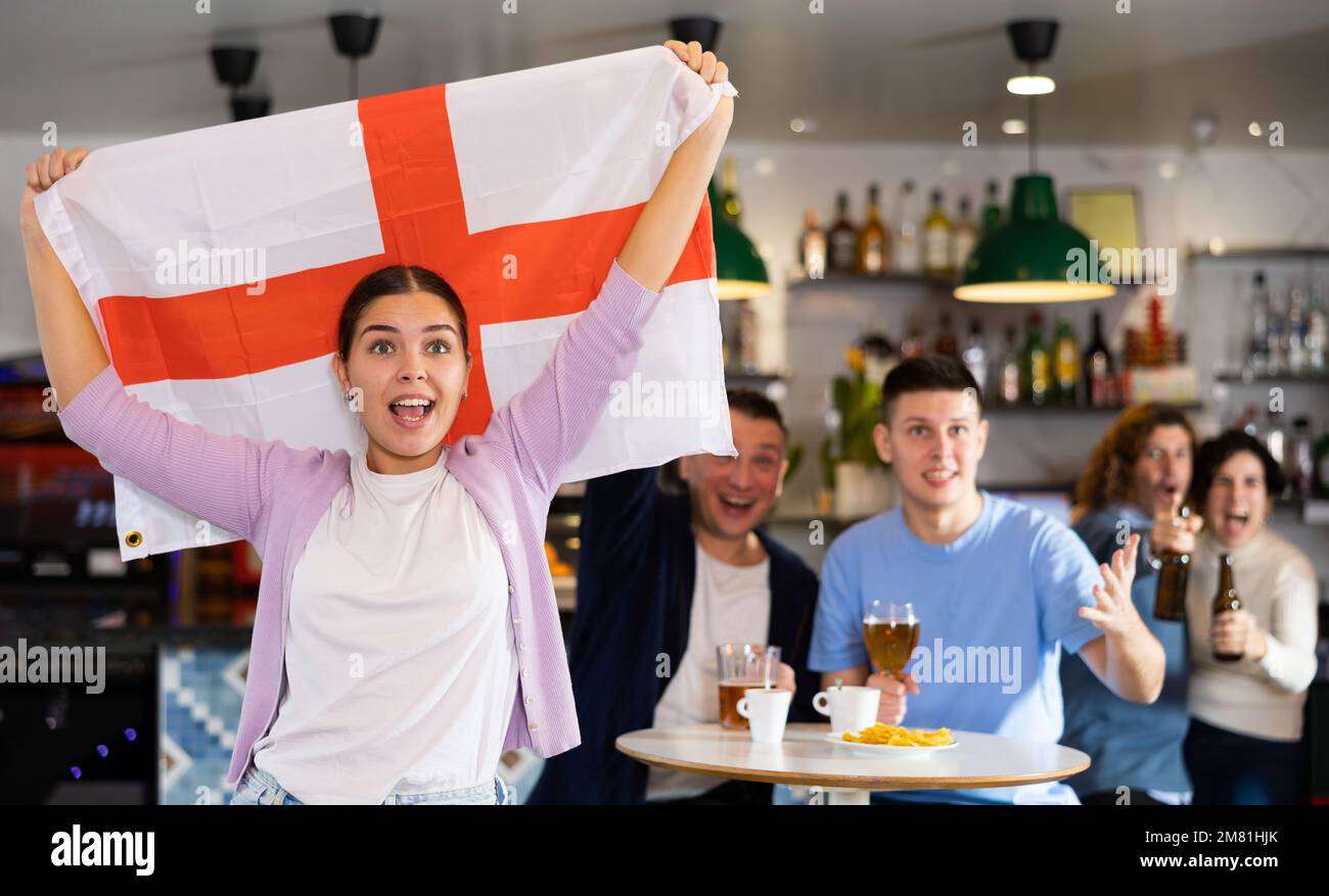 Group of people with England flag toasting with beer, having fun at ...