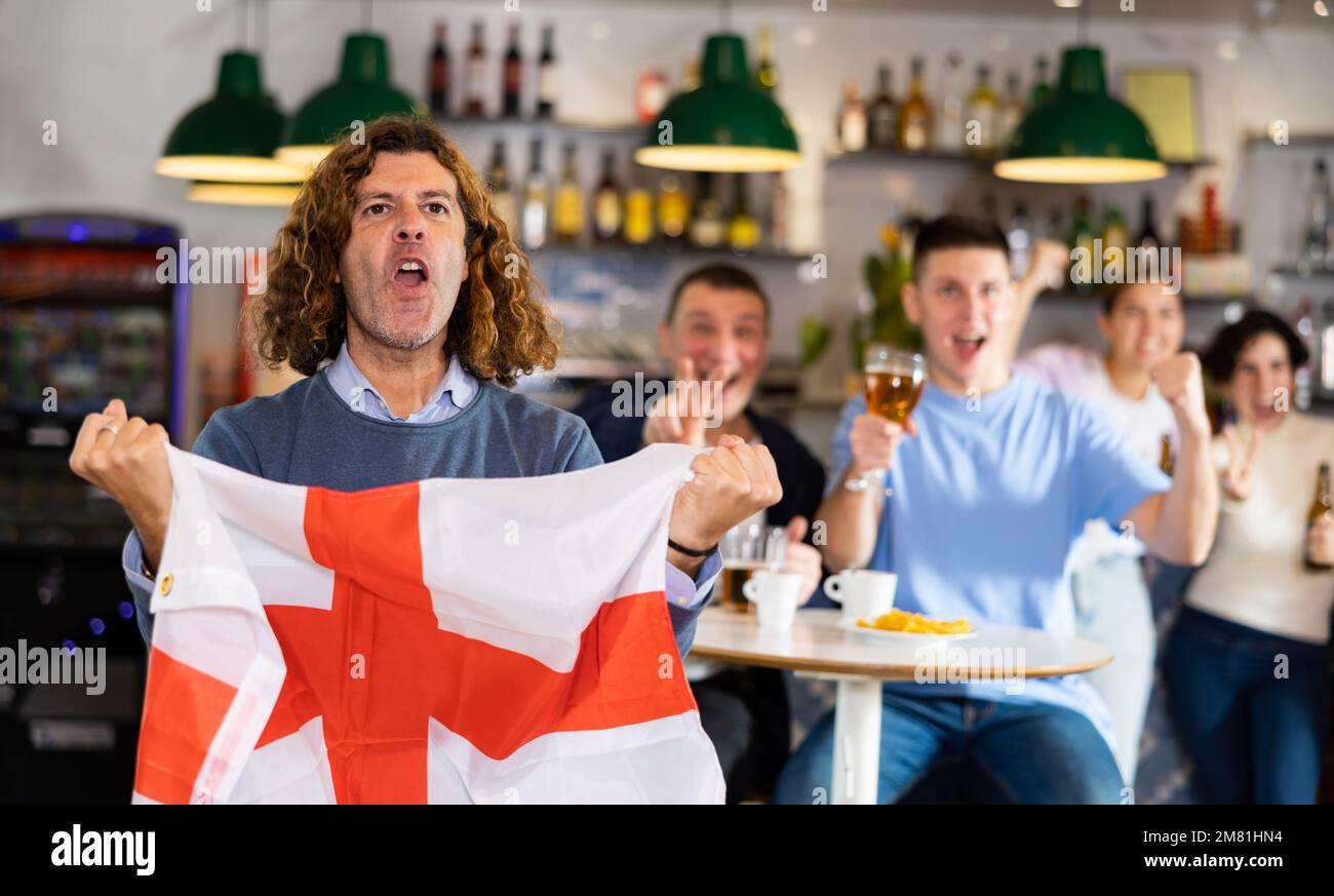 Group of people with England flag toasting with beer, having fun at ...